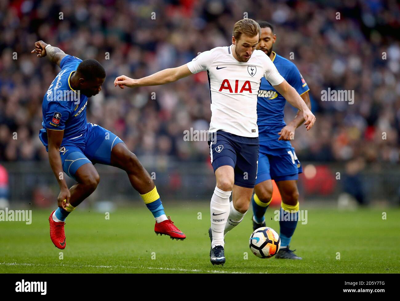Tottenham Hotspur's Harry Kane (centre) battles for the ball with AFC ...
