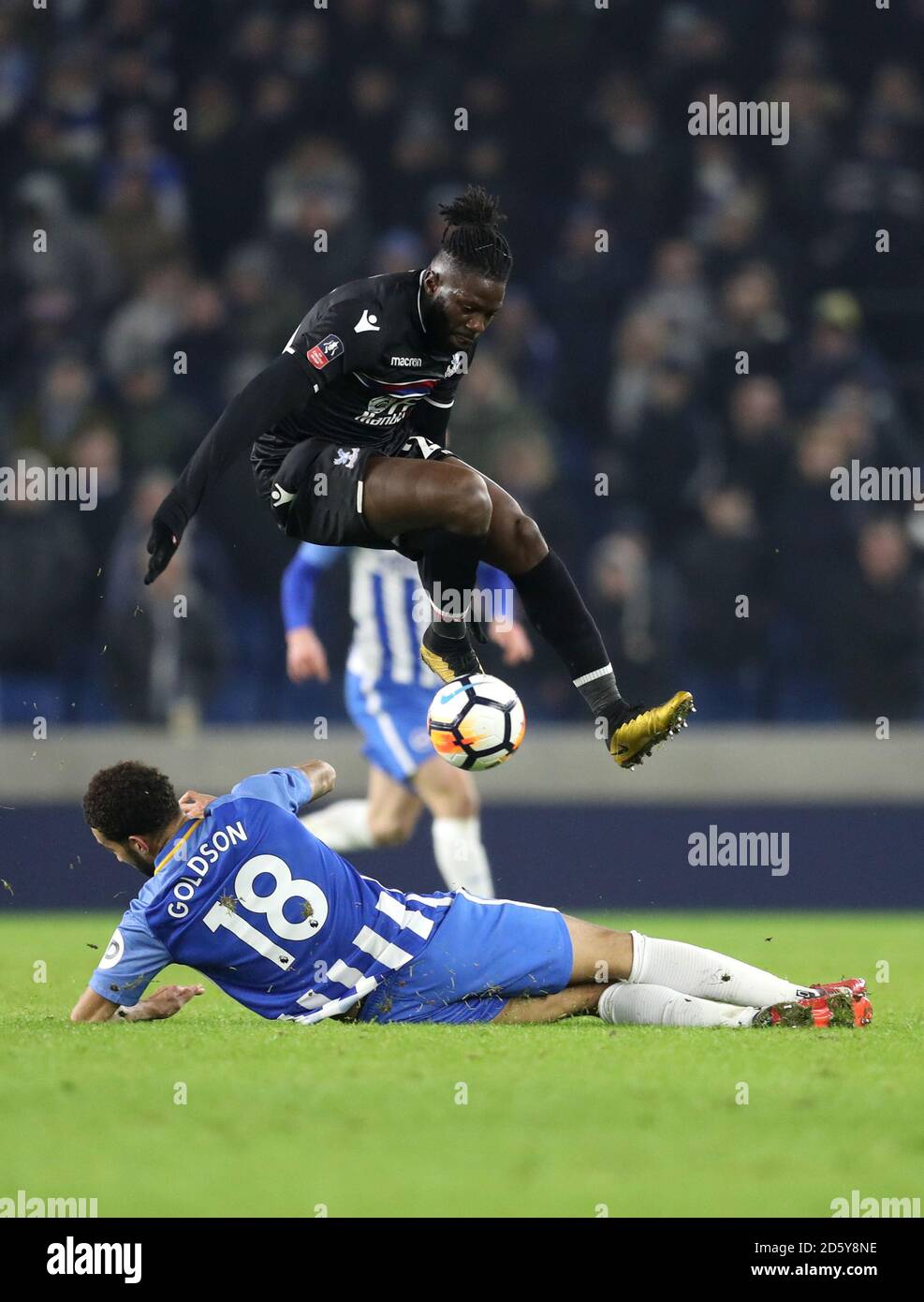 Crystal Palace's Bakary Sako jumps over a challenge from Brighton ...