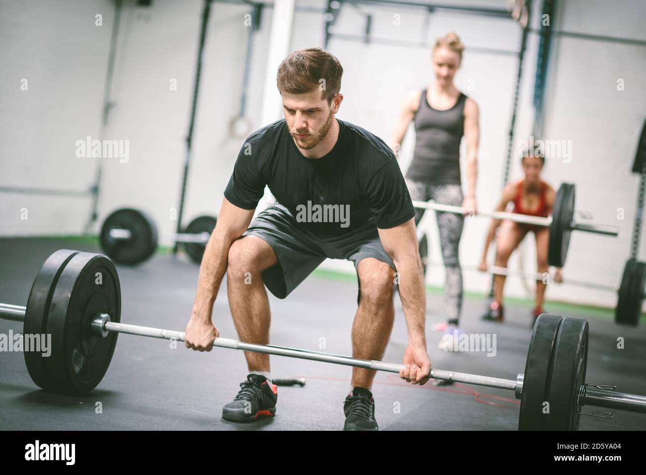 People in gym lifting weights Stock Photo - Alamy