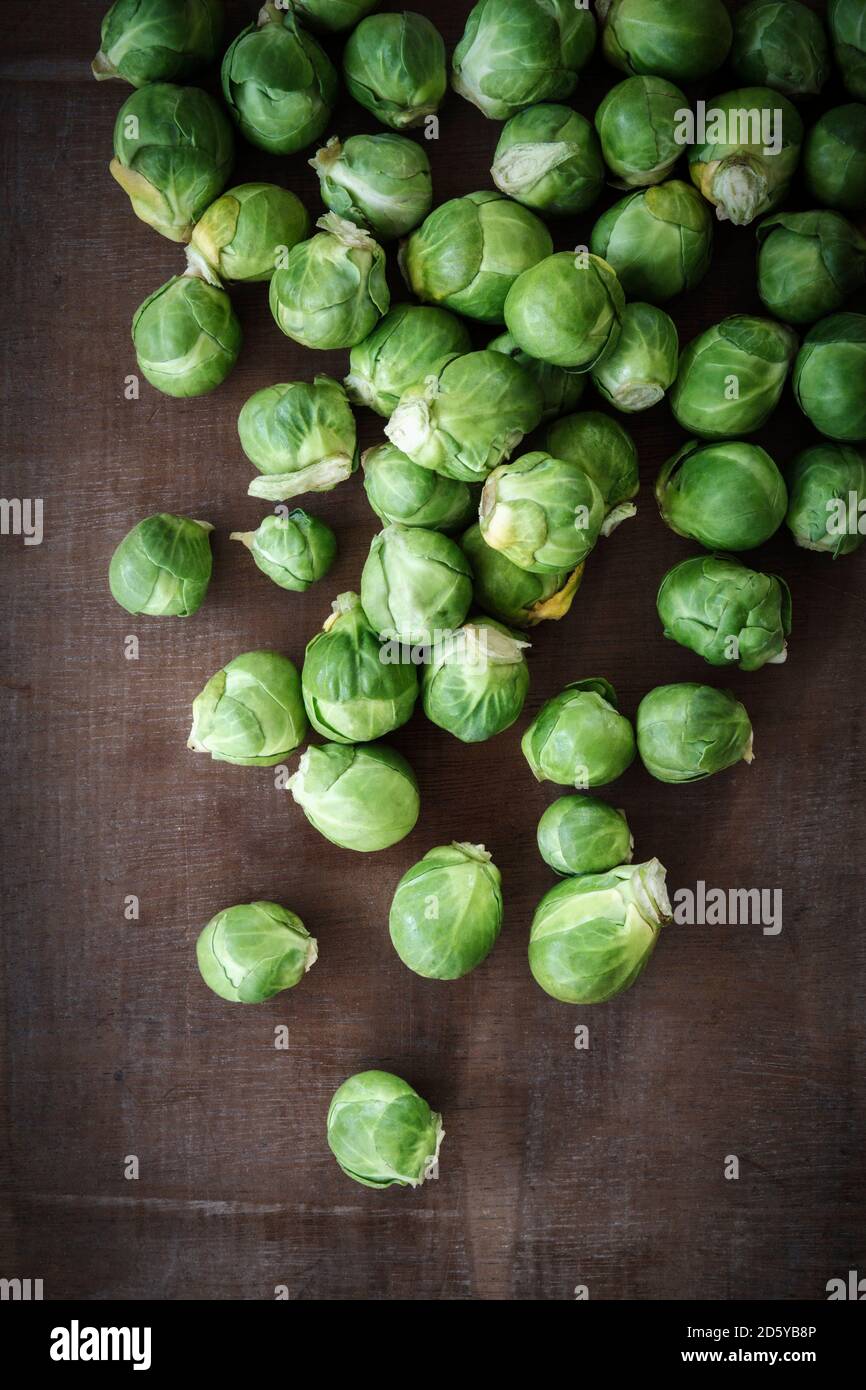 Brussels sprouts on dark wood Stock Photo - Alamy