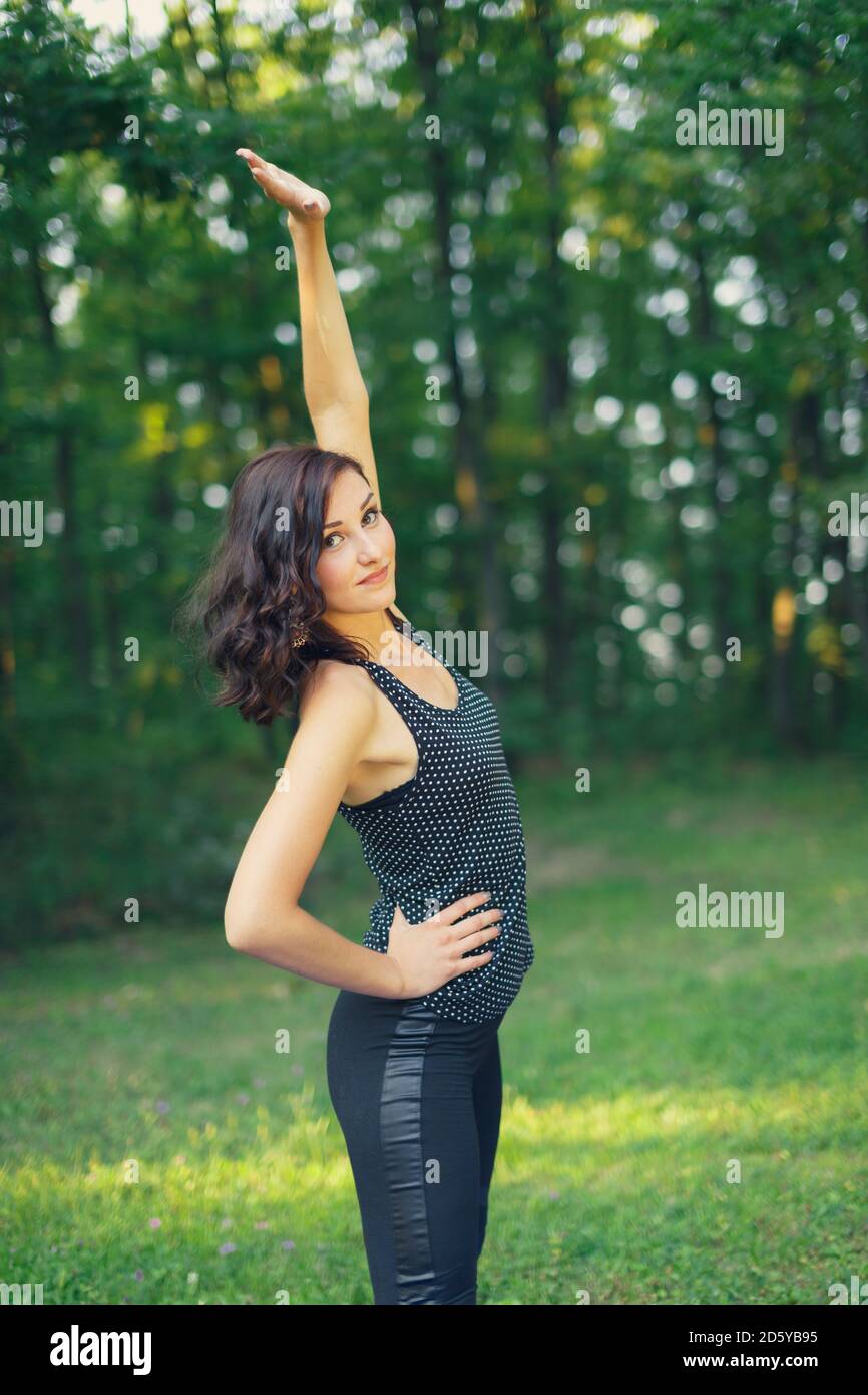 Woman stretching out in nature, yoga in nature Stock Photo - Alamy