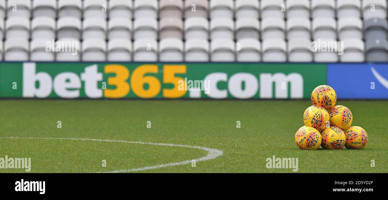 Bet365.com branding next to footballs on the pitch Stock Photo - Alamy