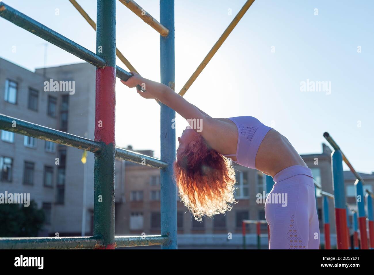a young athlete does an exercise in the arch of the spine to stretch ...