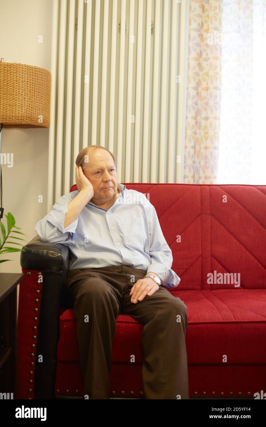 Age demented senior man sitting on couch in a nursing home Stock Photo ...