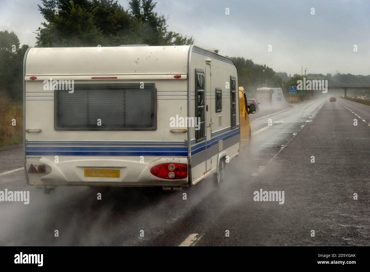 Caravan on motorway in rain Stock Photo - Alamy