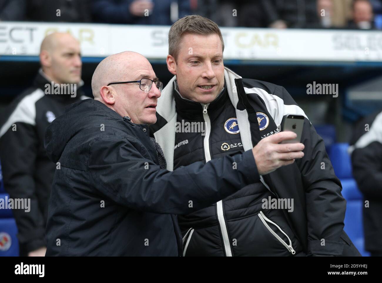 Millwall manager Neil Harris (right) has a selfie taken with a fan ...