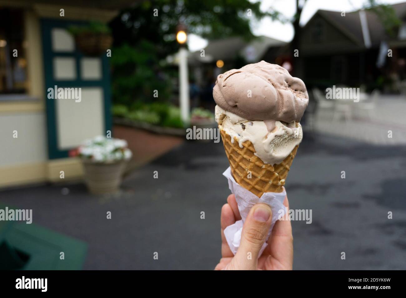 Soft focus of Ice Cream Cone. A hand holding an ice cream cone with ...