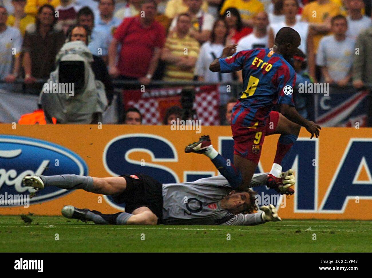 Arsenal goalkeeper Jens Lehmann brings down Barcelona's Samuel Eto'o ...
