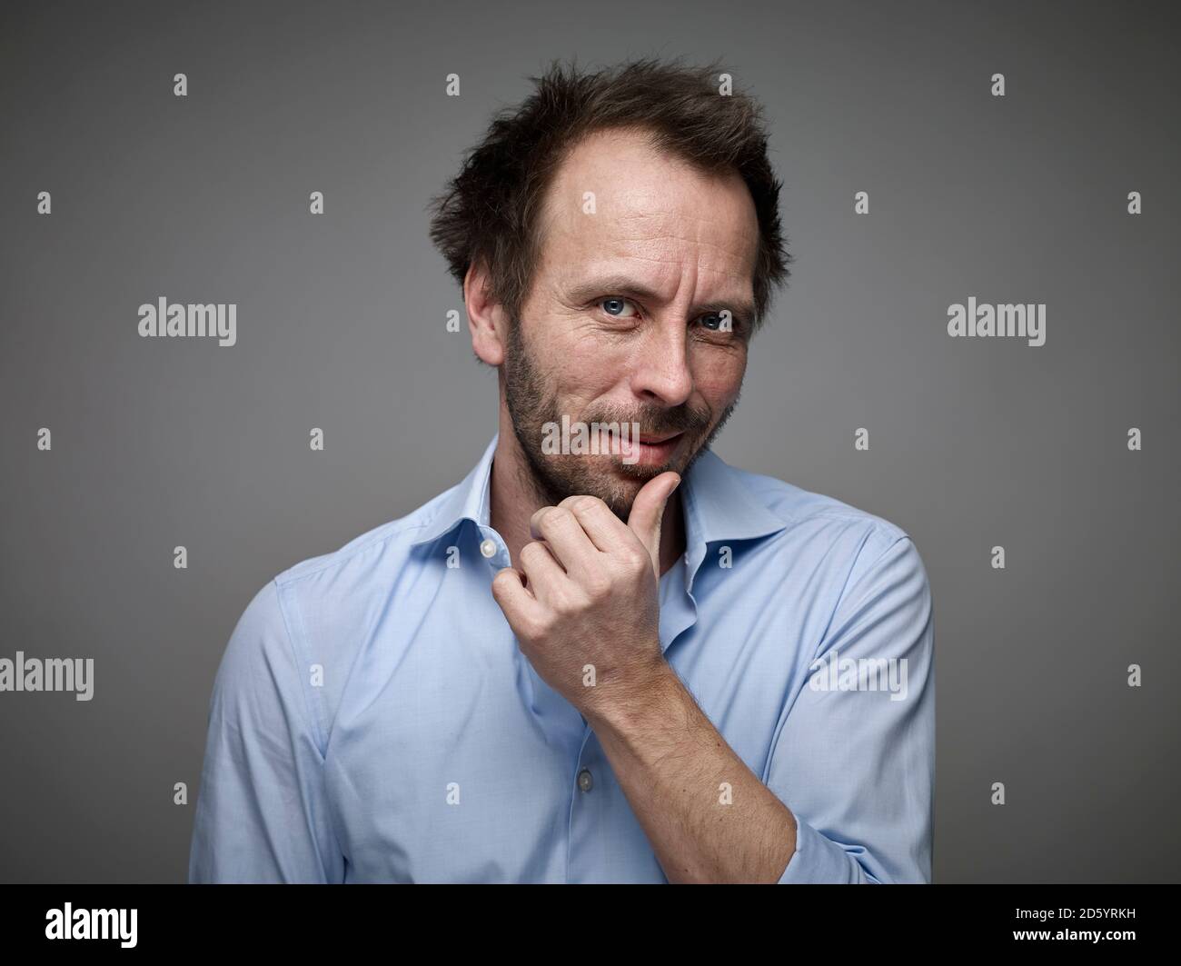 Portrait of man with han on his face Stock Photo - Alamy