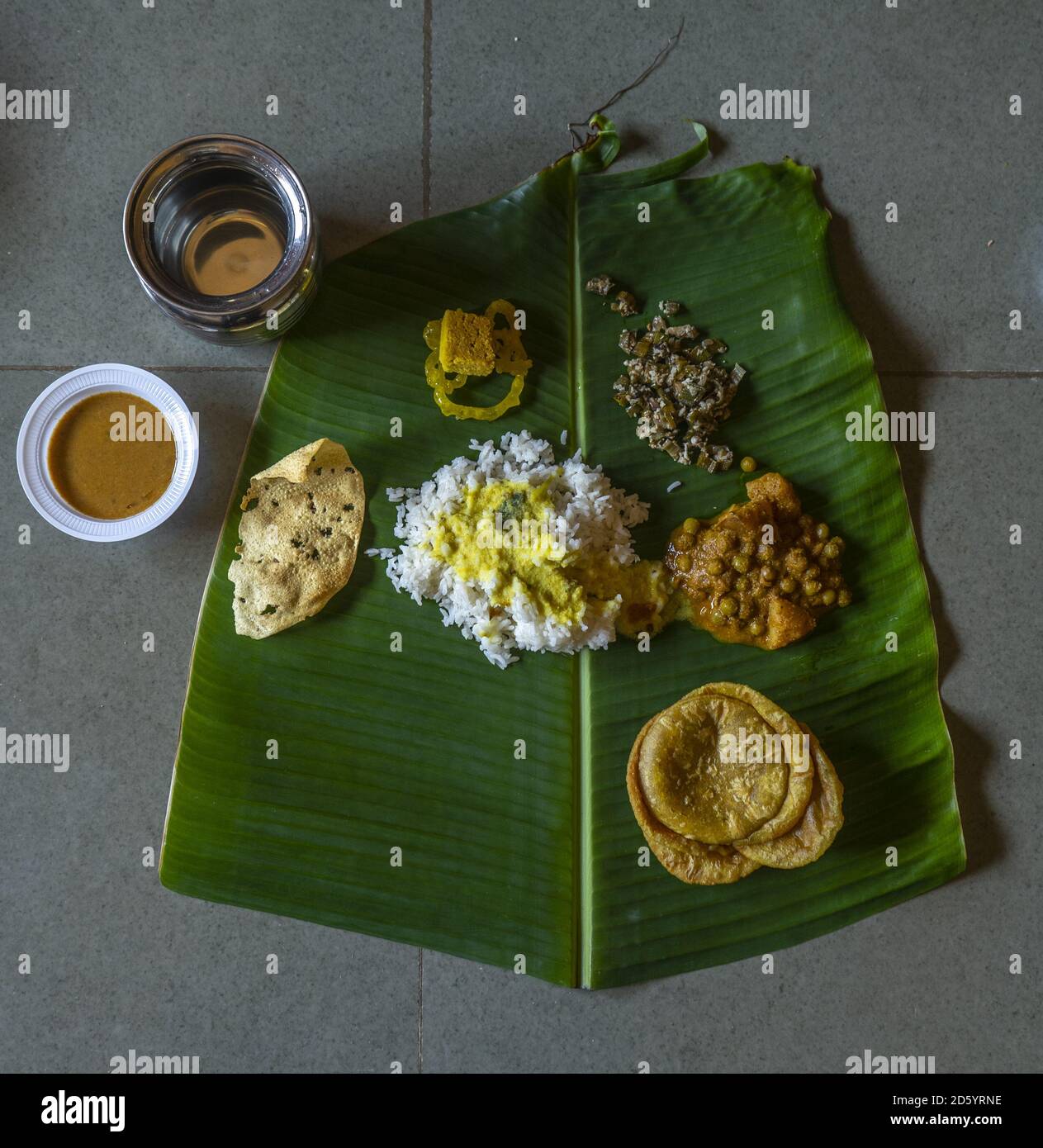Top view of an Indian thali combination of food served in banana leaf ...