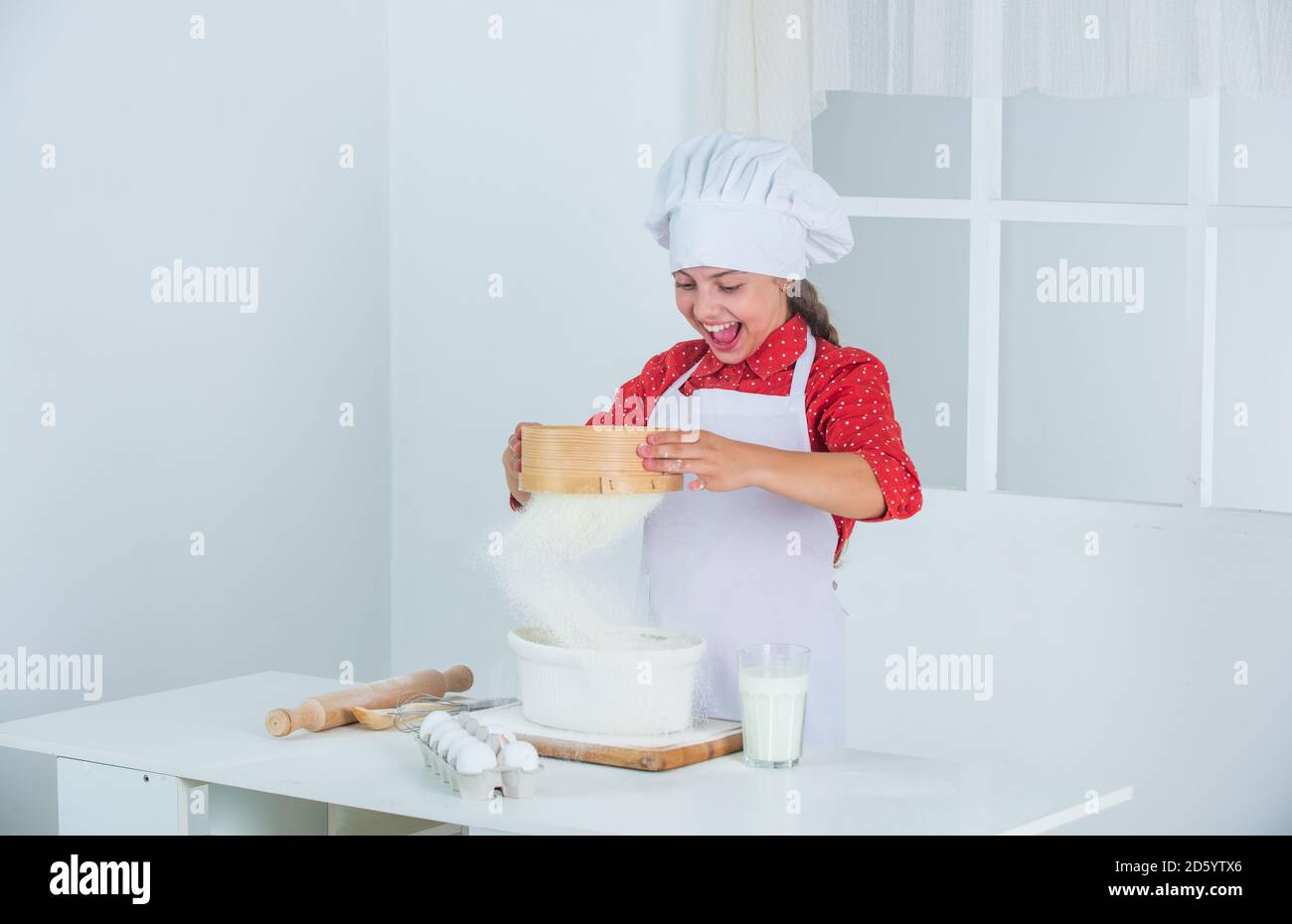 young baker kid in chef uniform, cooking Stock Photo - Alamy