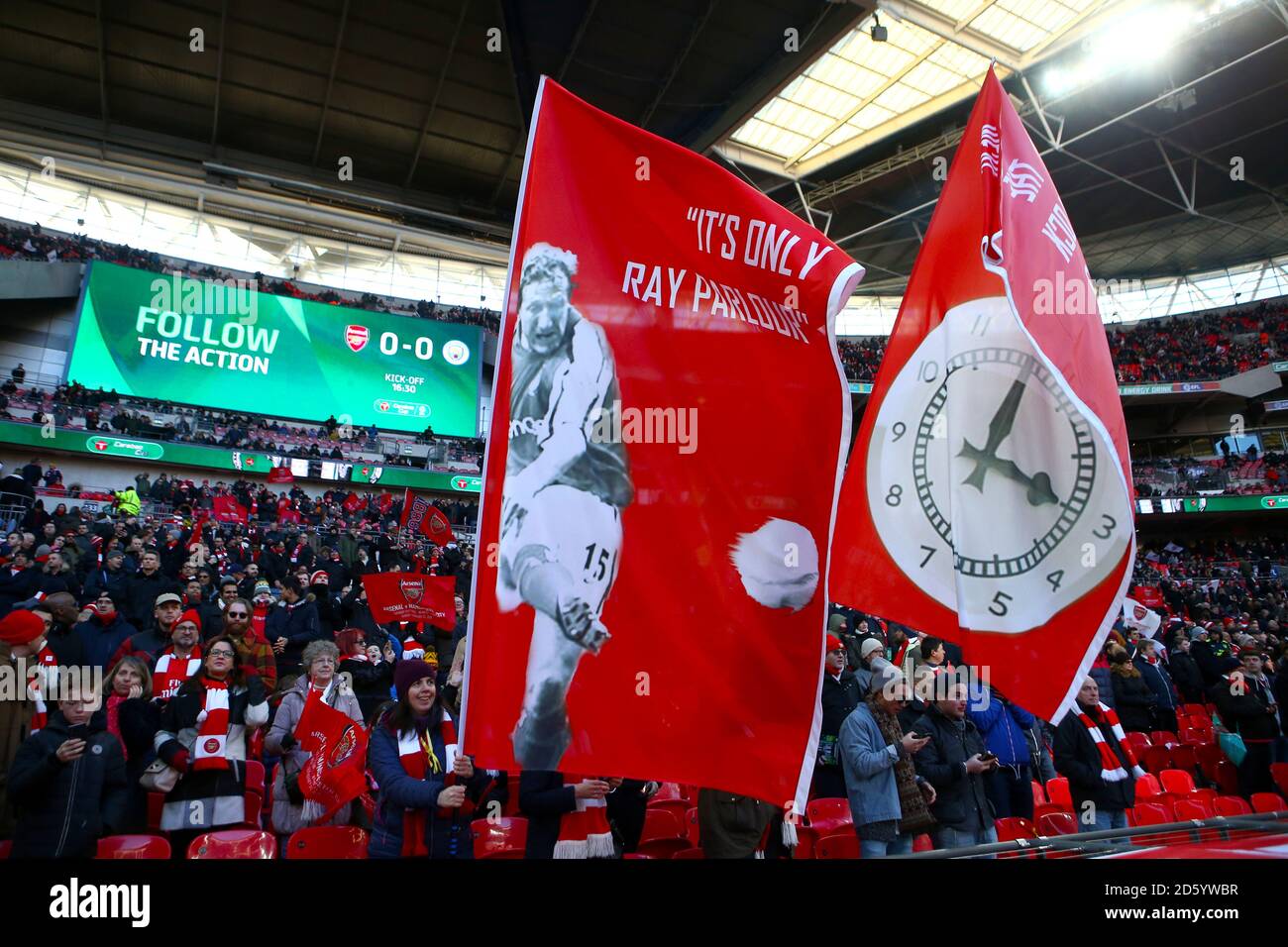 Arsenal fans wave flags in the stands ahead of the match Stock Photo ...