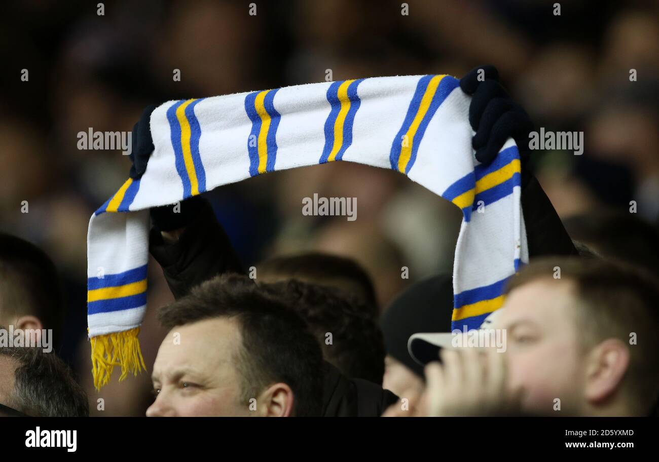 A Leeds United fan holds their scarf aloft in the stands Stock Photo ...