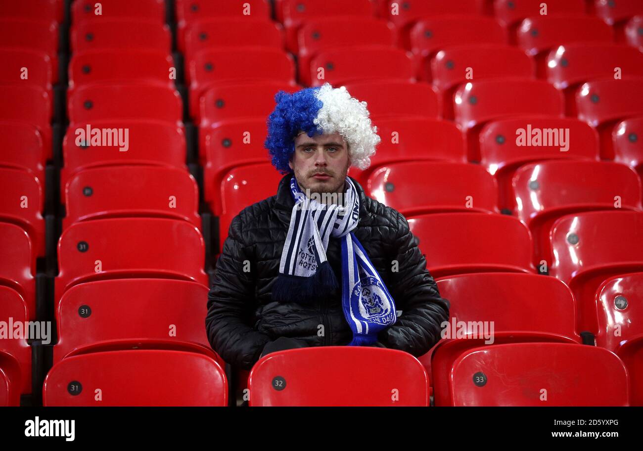 A fan in a half and half scarf sits in an empty stand Stock Photo - Alamy