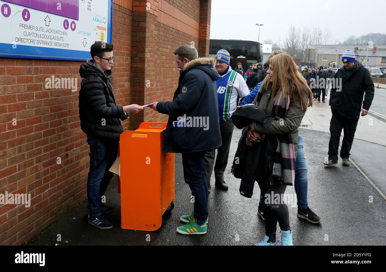 A programme seller stands outside Blackburn Rovers Ewood Park stadium ...