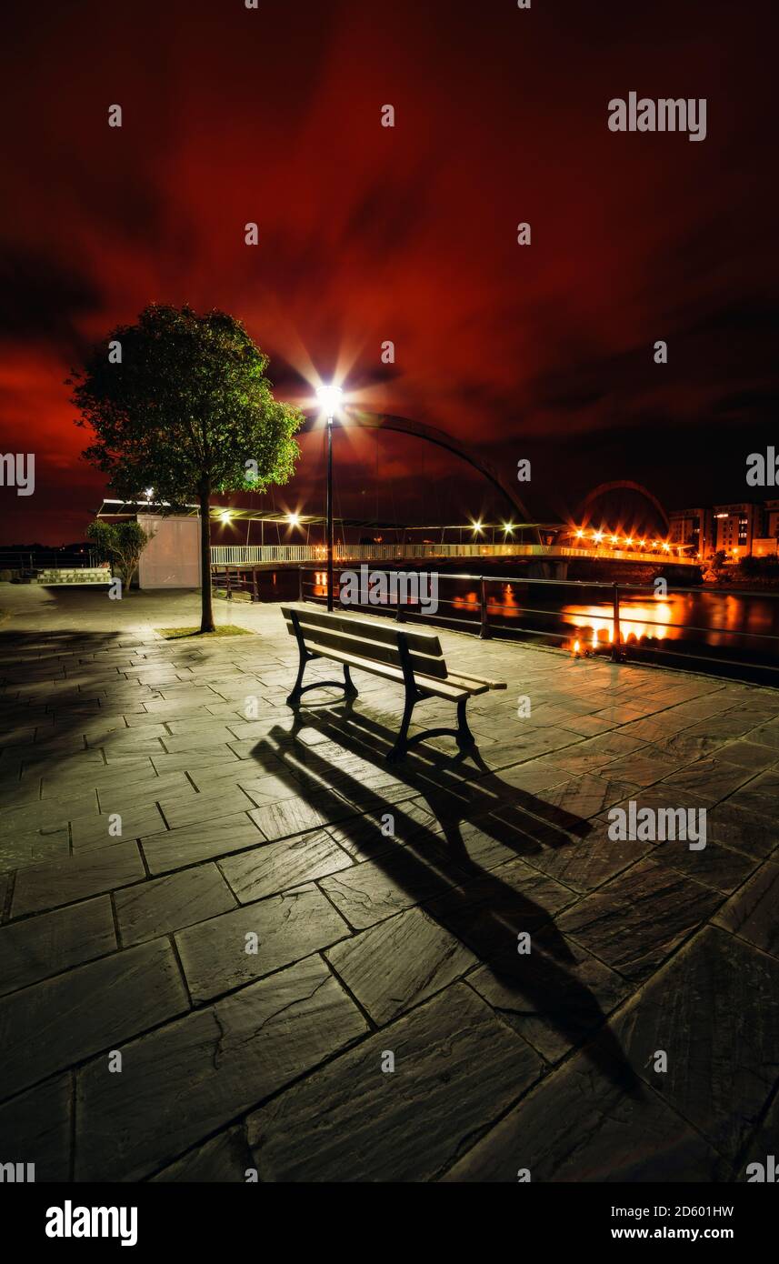 Spain, Galicia, Naron, Promenade with a bench in the foreground at ...