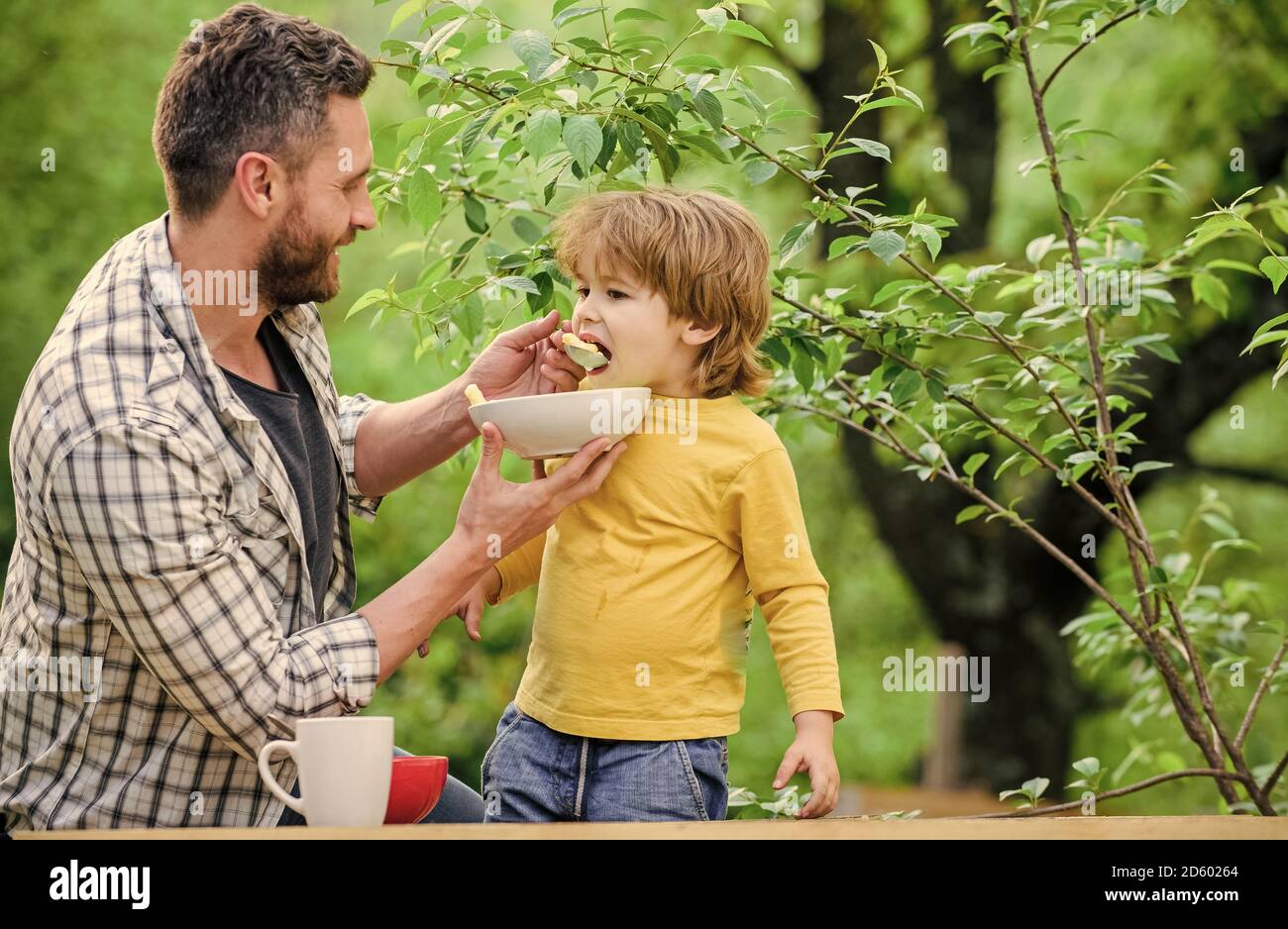 family and parenting. happy fathers day. Little boy with dad eat cereal ...