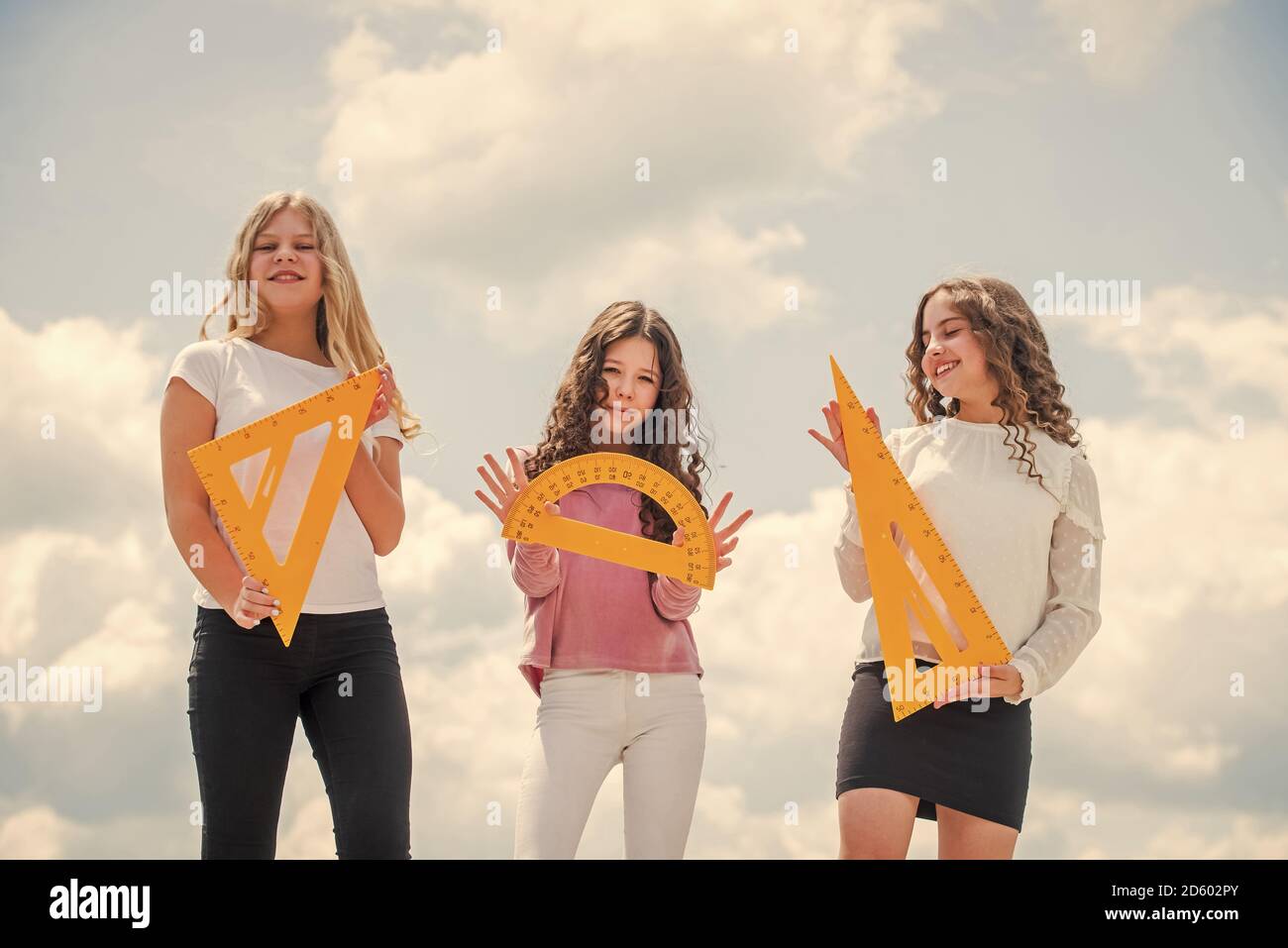 high school. three girls with protractor and triangle ruler. back to ...