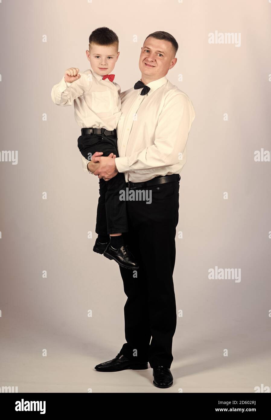 Gentleman upbringing. Father carry hug son formal clothes outfit. Grow ...