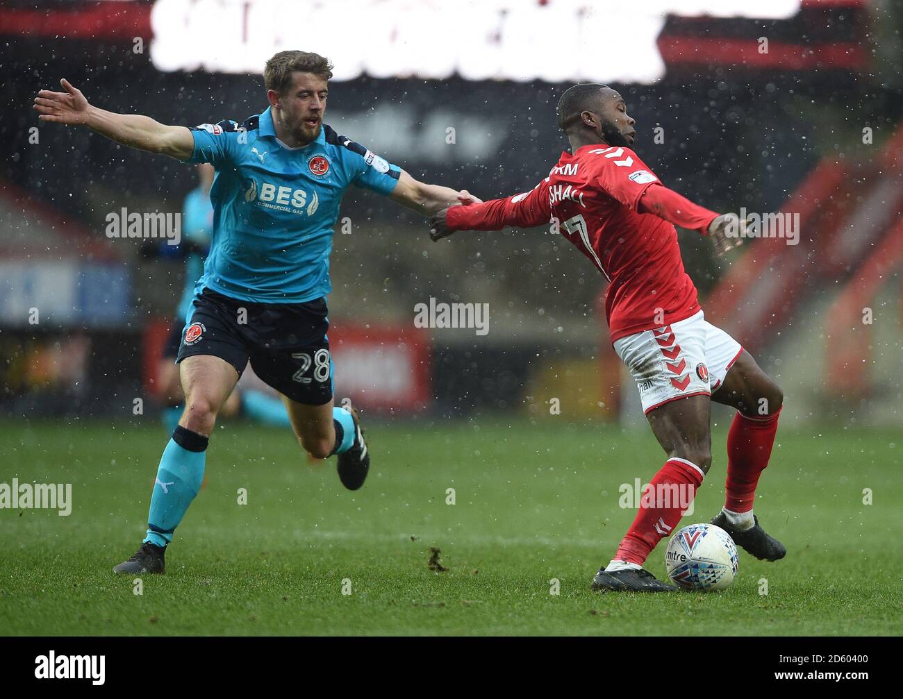 Fleetwood Town's Jack Sowerby (left) holds back Charlton Athletic's ...