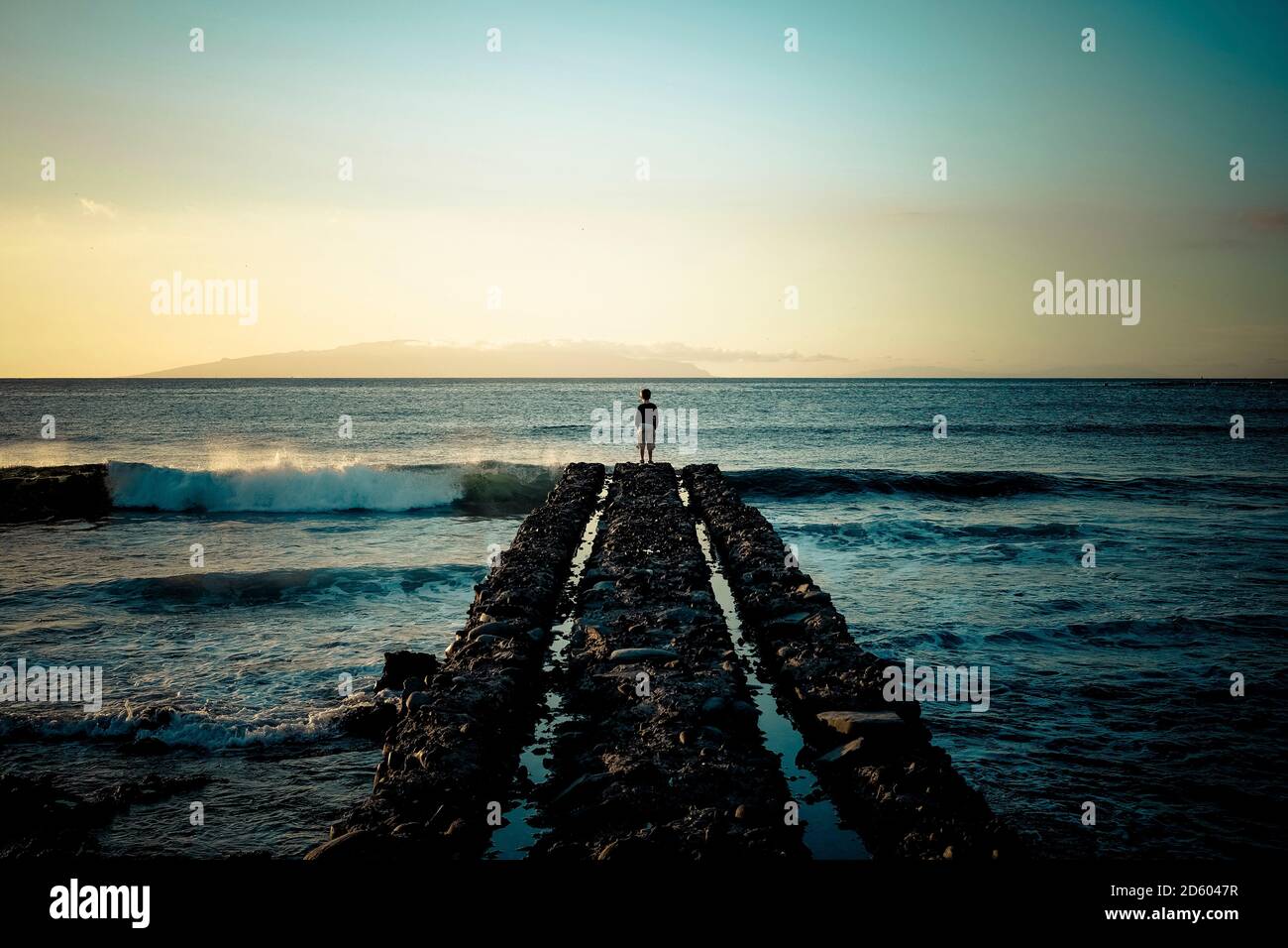 Spain, Canary Islands, Tenerife, back view of child standing at pier ...