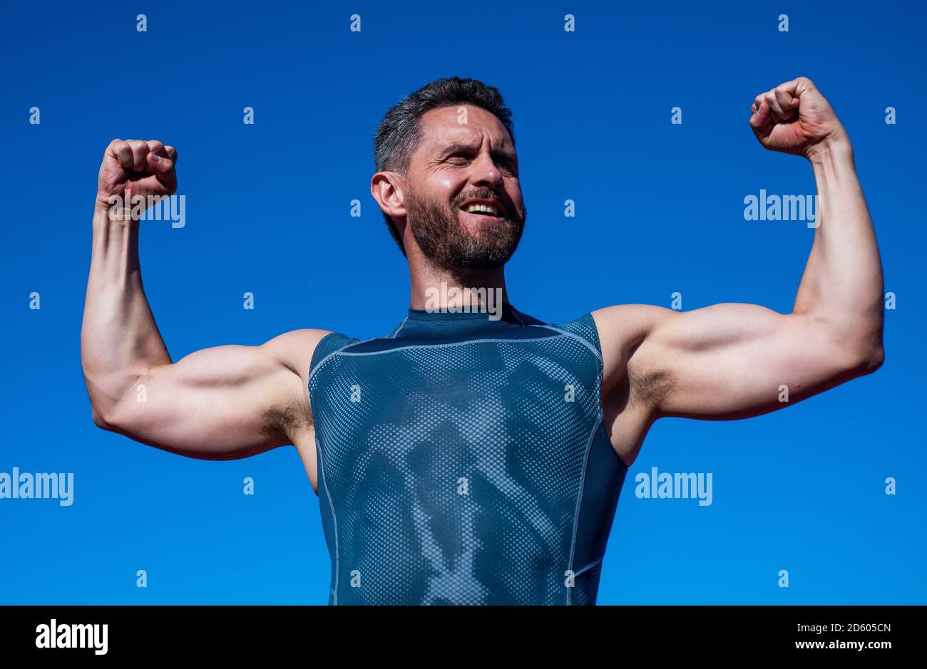 sport success. male strength and power. sportsman on sky background ...