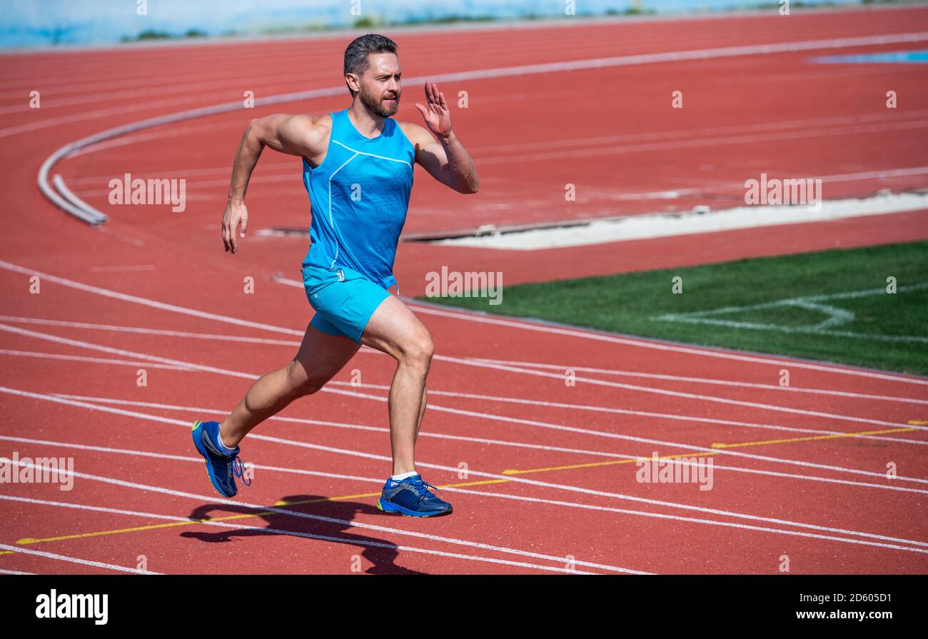 Dynamic movement of male runner on running track, run Stock Photo - Alamy