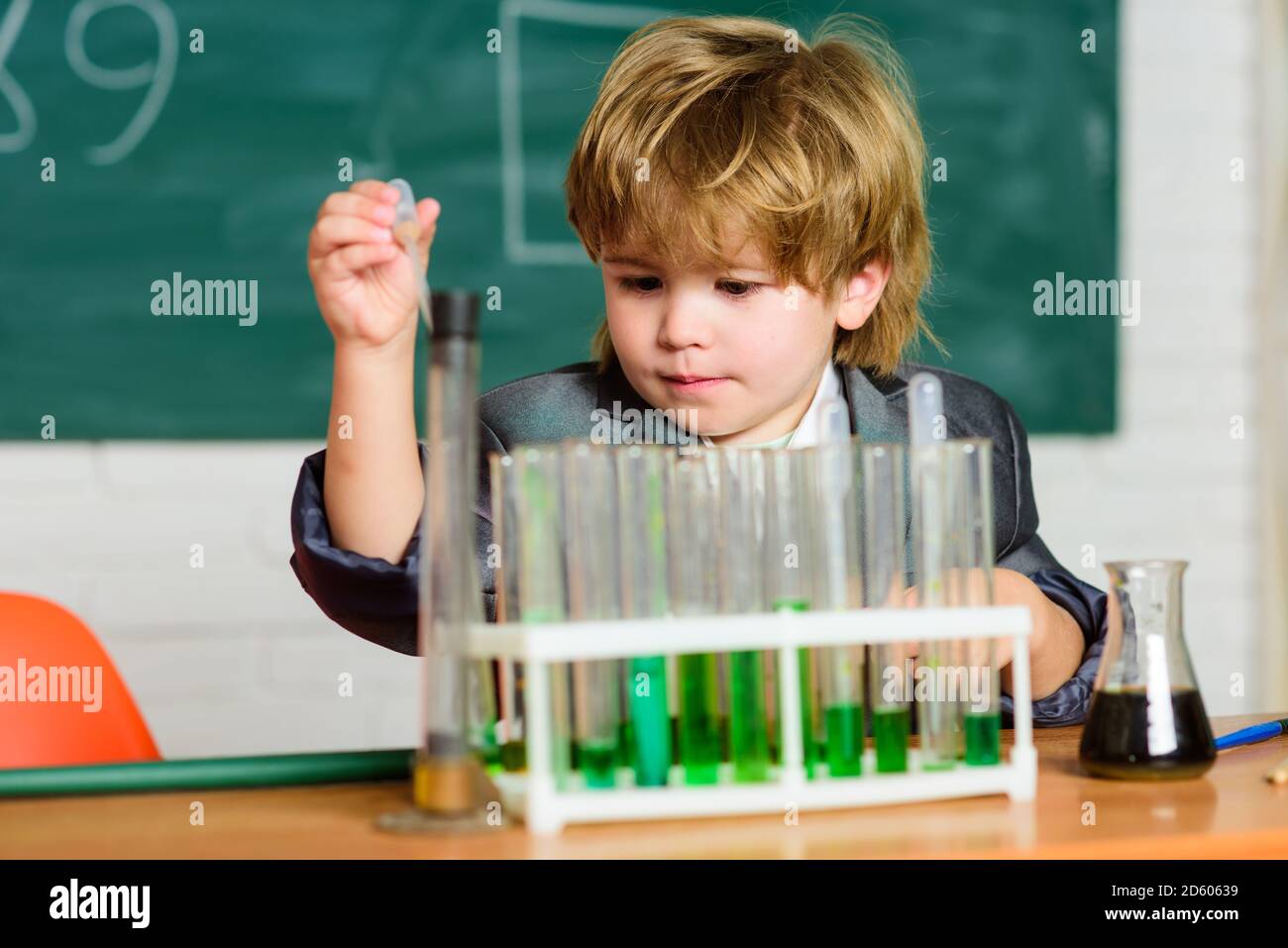 Little boy is making science experiments. school kid scientist studying ...