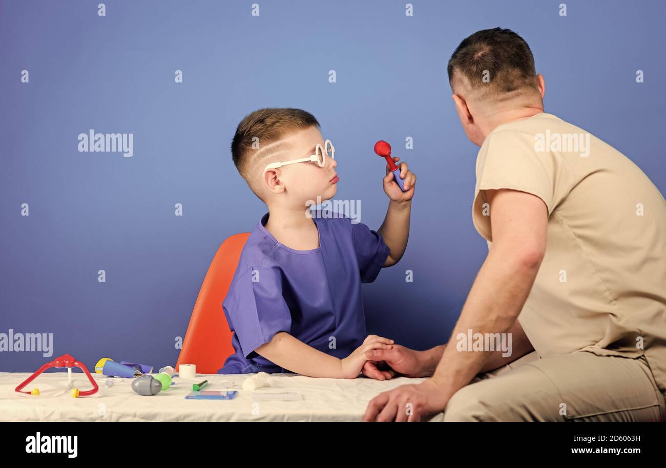 Medicine concept. Kid little doctor sit table medical tools. Illness ...