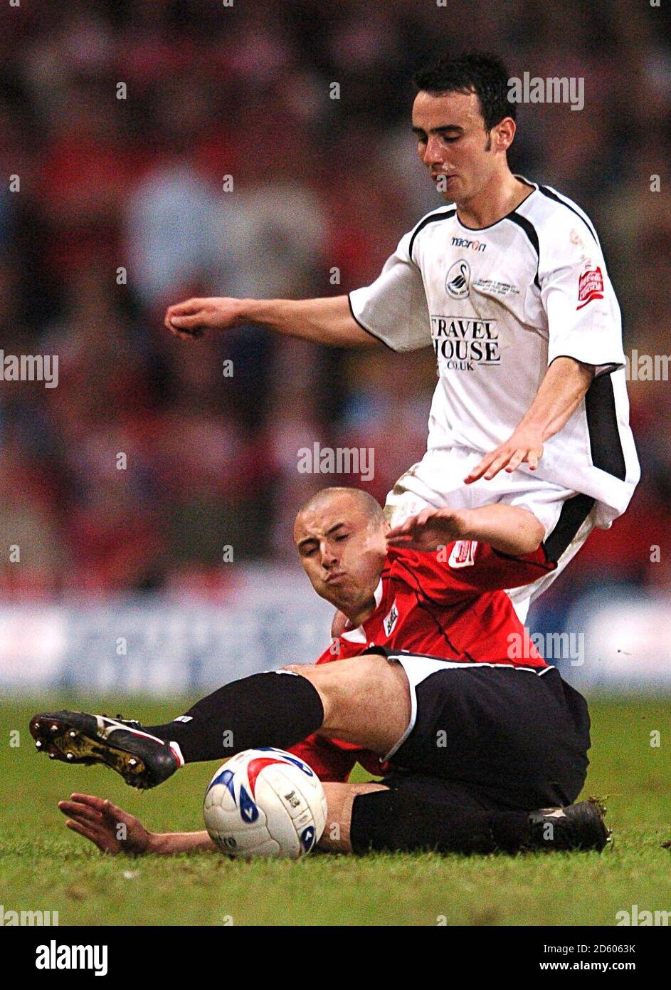 Barnsley's Antony Kay (bottom) and Swansea City's Leon Britton battle ...
