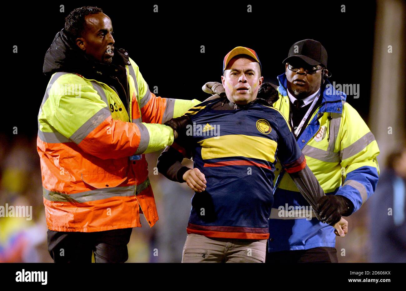 Stewards with pitch invaders after the game Stock Photo - Alamy
