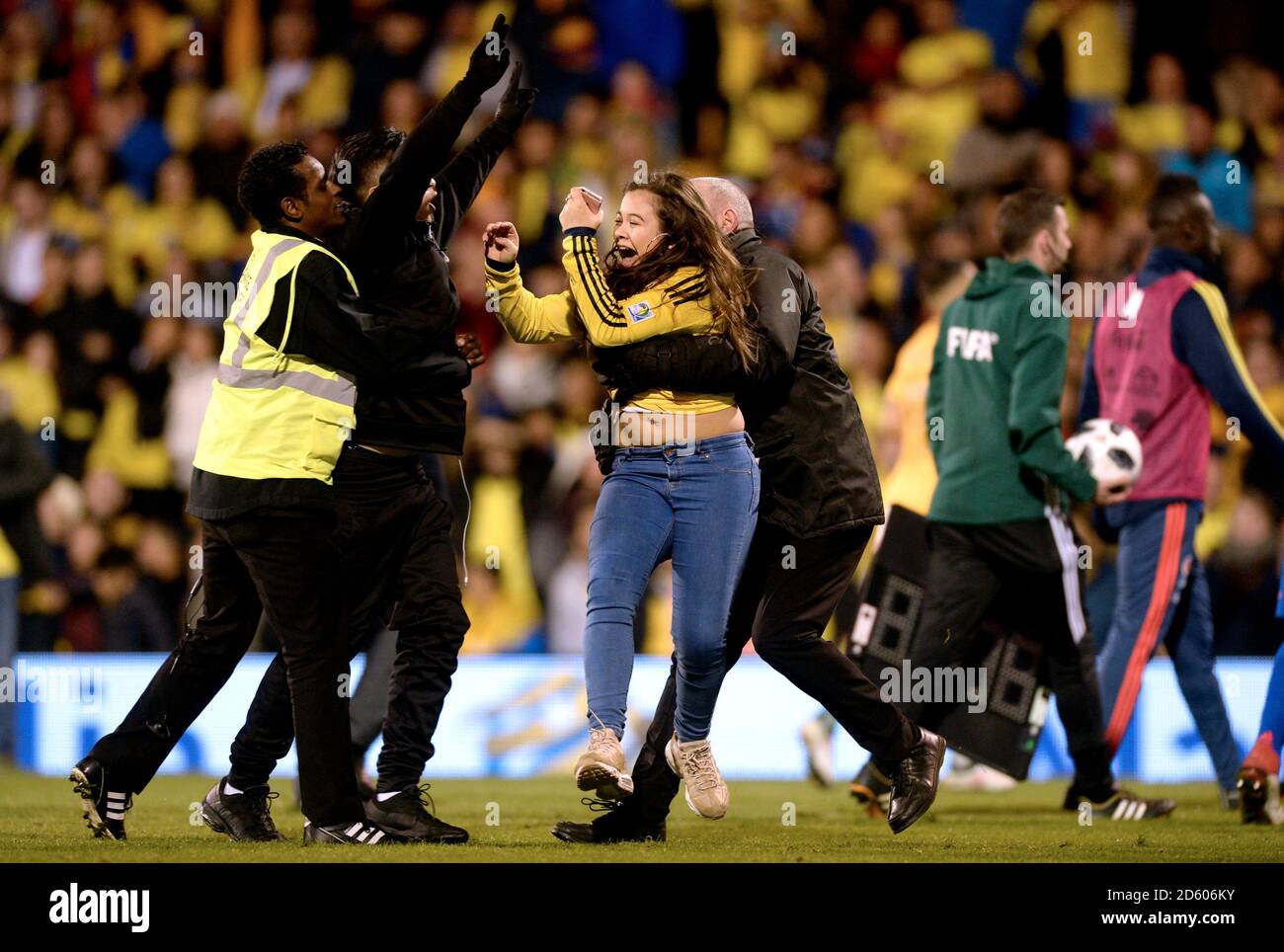 Stewards with pitch invaders after the game Stock Photo - Alamy