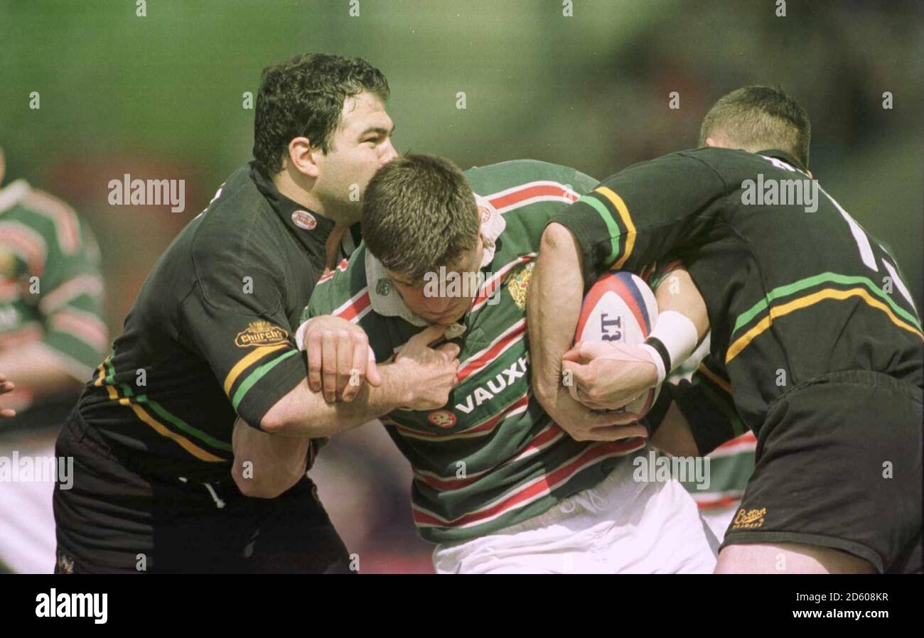 Leicester's Martin Corry (c) is tackled by Northampton's Federico ...