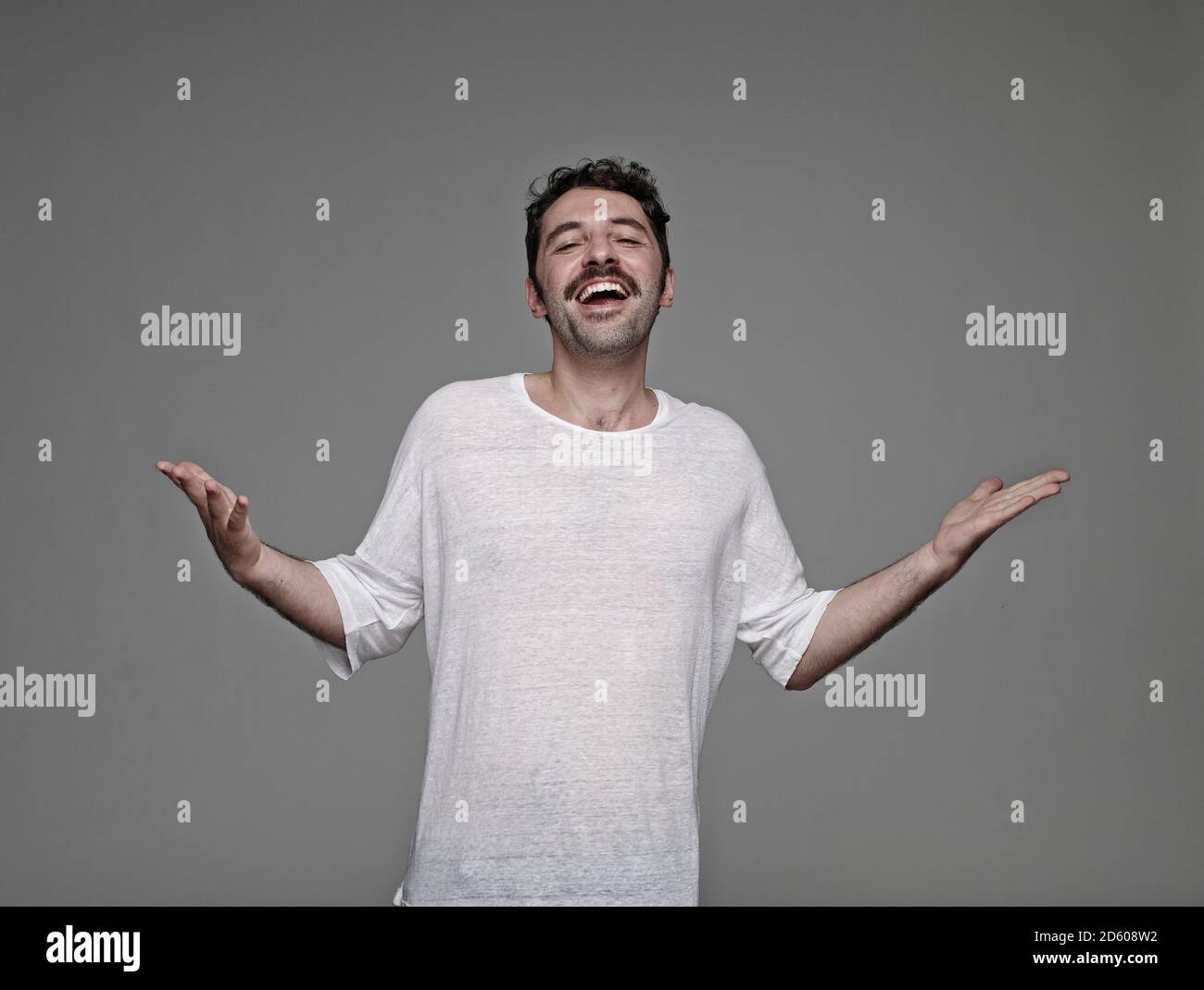 Portrait of arrogant man in front of grey background Stock Photo - Alamy