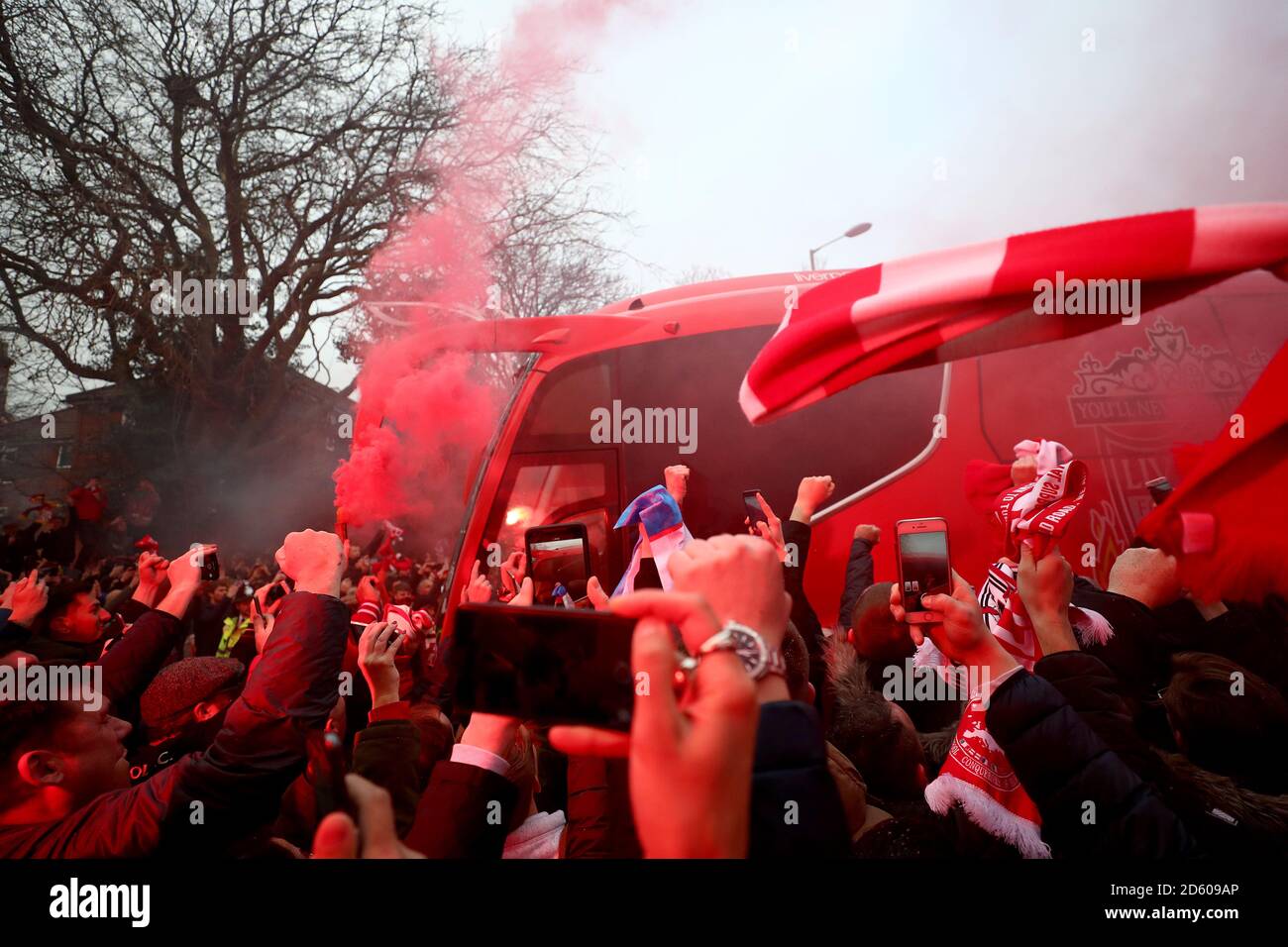 Liverpool fans set off flares as their team arrives on a coach Stock ...