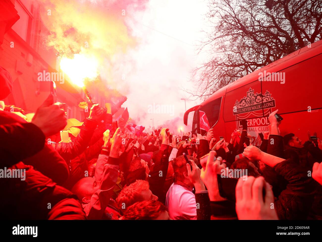 Liverpool fans set off flares as their team arrives on a coach Stock ...