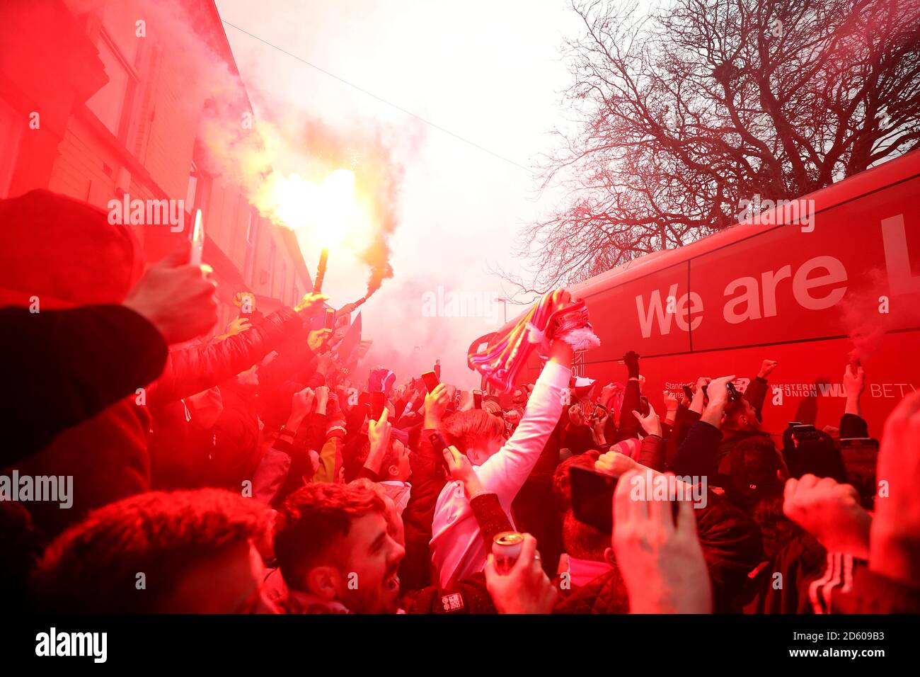 Liverpool fans set off flares and show support for their team as the ...