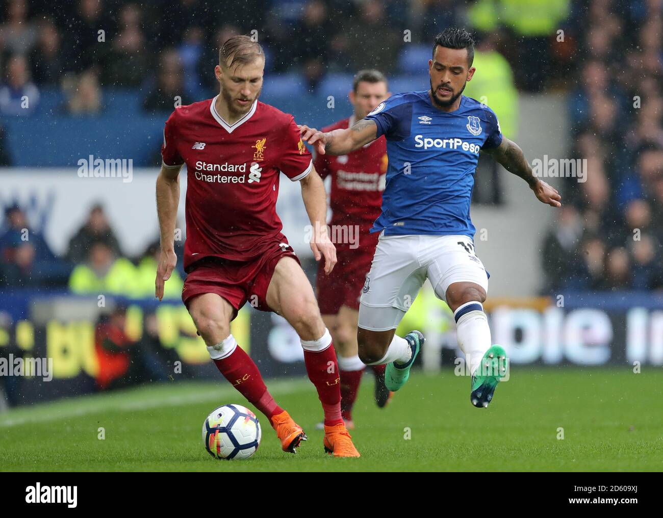 Liverpool's Ragnar Klavan (left) and Everton's Theo Walcott battle for ...