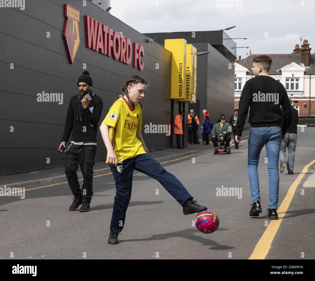 A Watford fan plays football outside Vicarage Road prior to the match ...