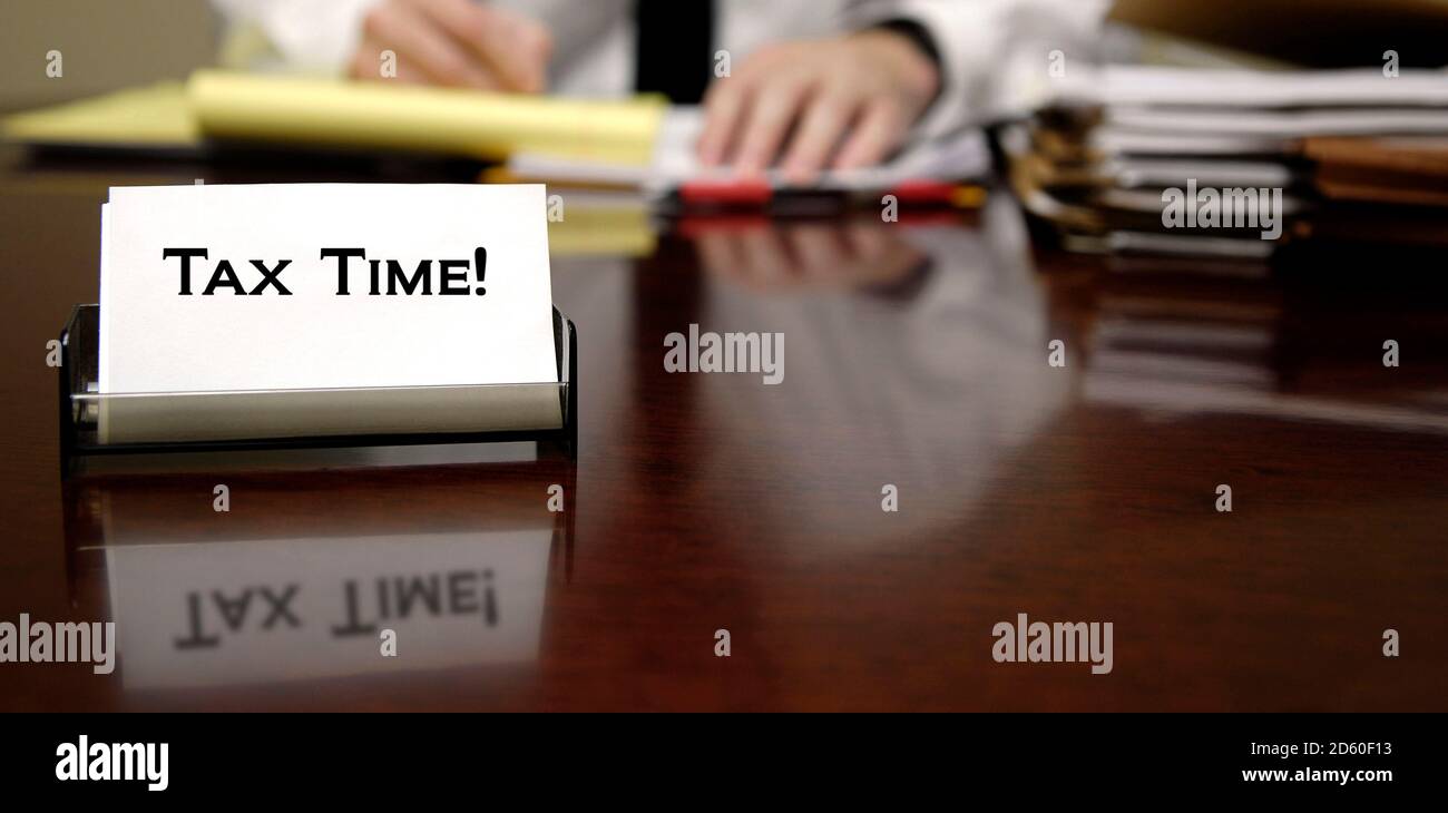 IRS tax auditor man sitting at desk with business card Stock Photo - Alamy