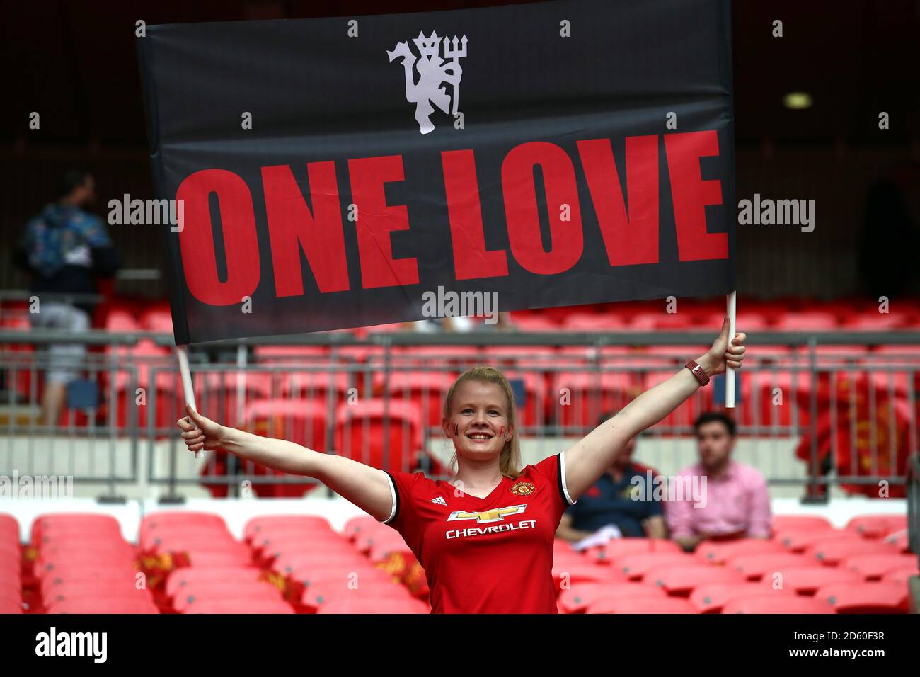 Manchester United fan holds up a 'One Love' flag prior to kick-off ...