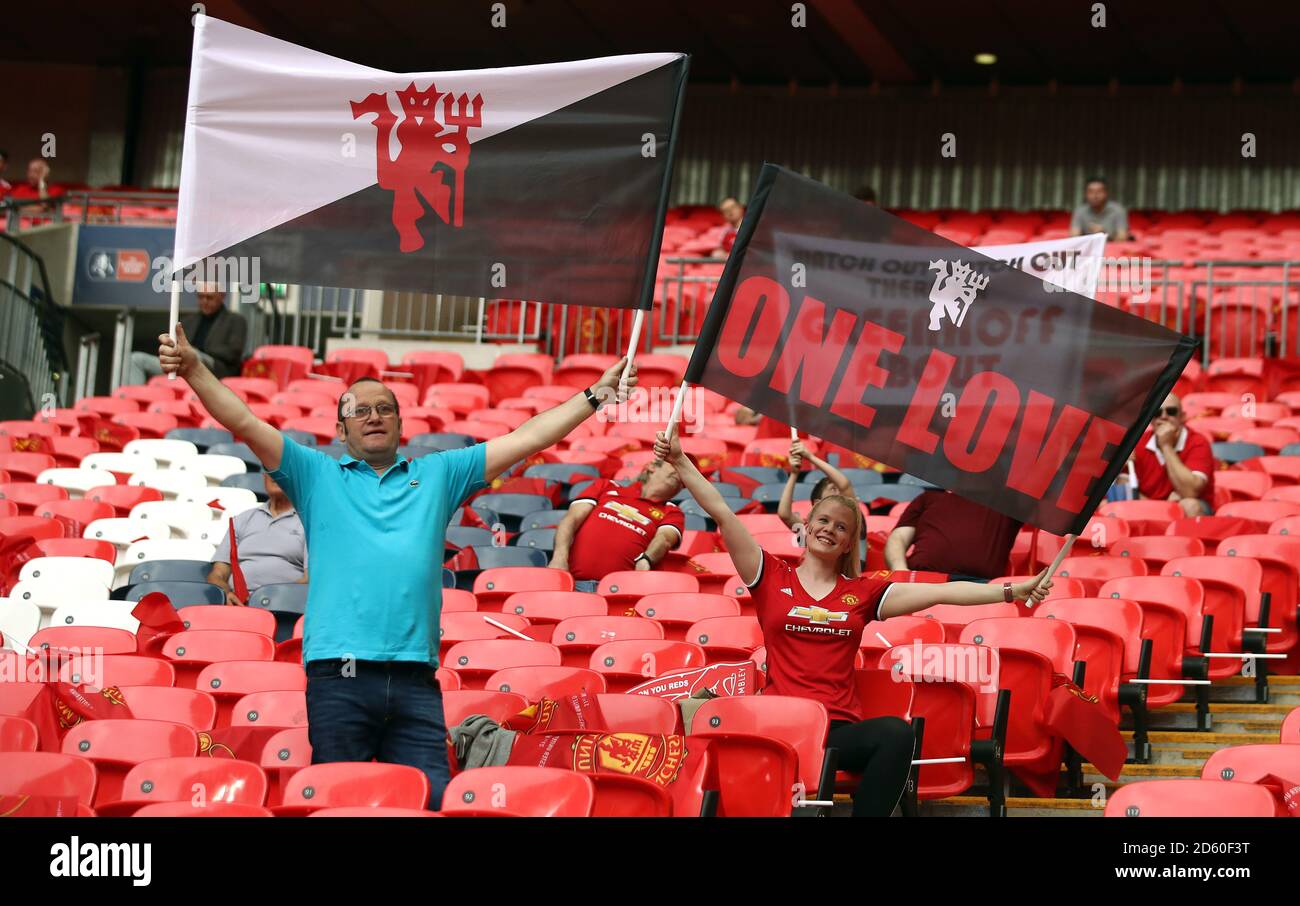 Manchester United fans with flags before the game Stock Photo - Alamy