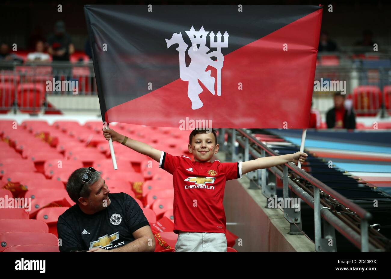 Manchester United fan holds up a flag prior to kick-off Stock Photo - Alamy