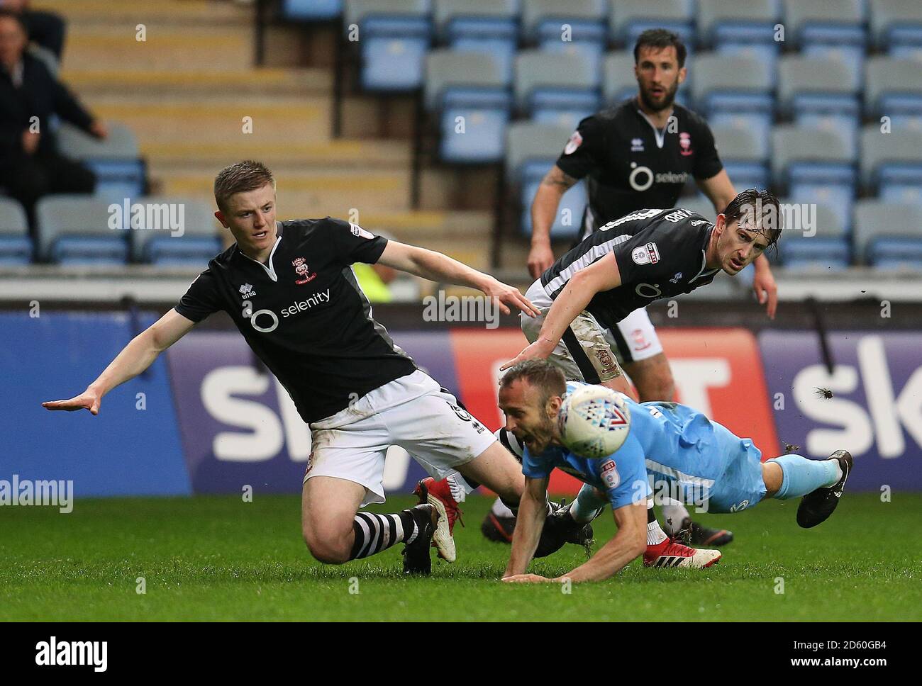 Coventry City's Liam Kelly and Lincoln City's Scott Wharton battle for ...