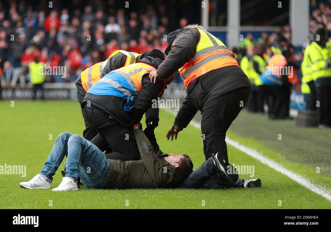 A pitch invader is restrained by security staff Stock Photo - Alamy