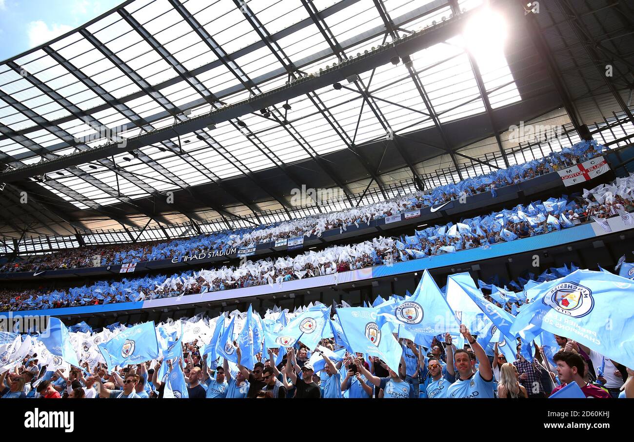 Manchester City fans wave flags during the game Stock Photo - Alamy