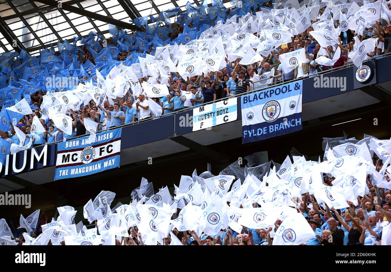 Manchester City fans wave flags during the game Stock Photo - Alamy