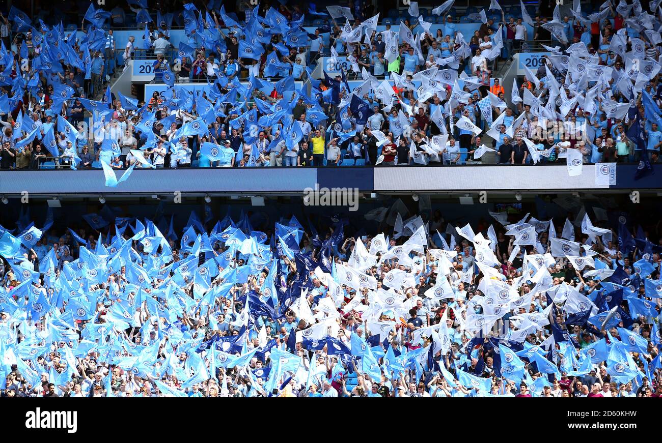 Manchester City fans wave flags during the game Stock Photo - Alamy