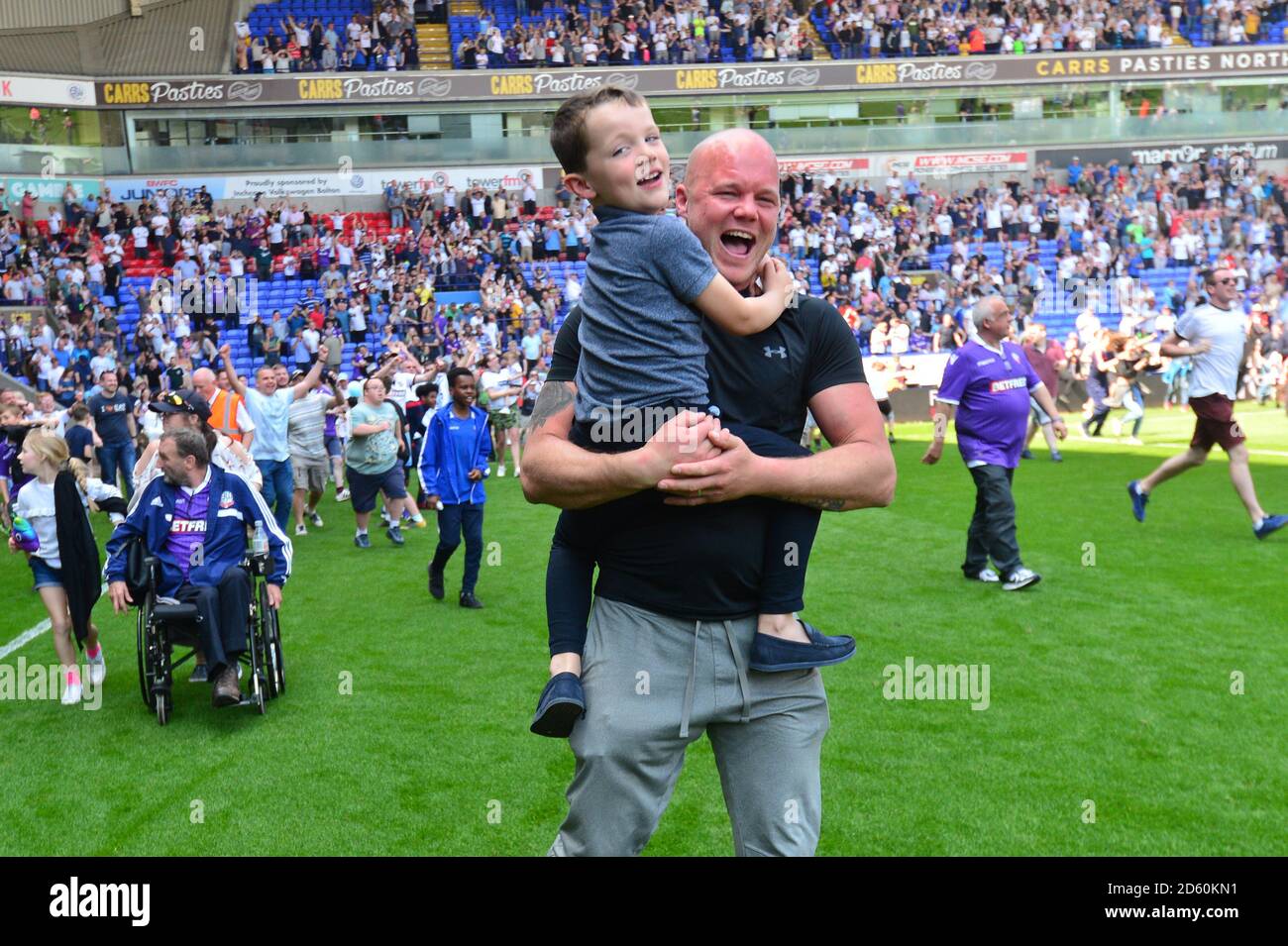 Bolton fans run onto the pitch after the final whistle Stock Photo - Alamy