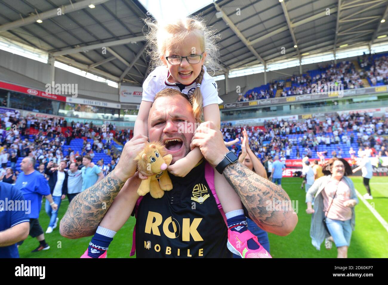 Bolton fans run onto the pitch after the final whistle Stock Photo - Alamy